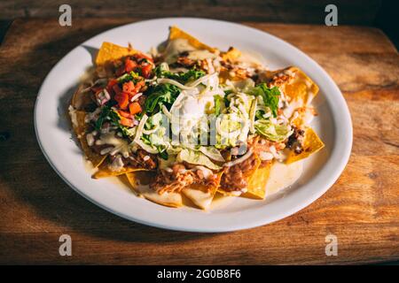 A plate of creamy nachos snack Stock Photo - Alamy