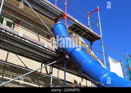 Debris chute for the disposal of building rubble Stock Photo - Alamy