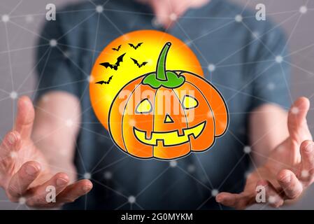 Halloween concept between hands of a man in background Stock Photo - Alamy