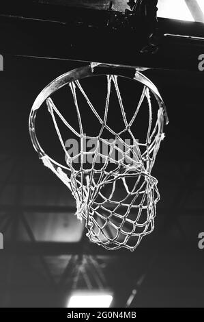 Indoor basketball basket net of white rope view from underneath against ...