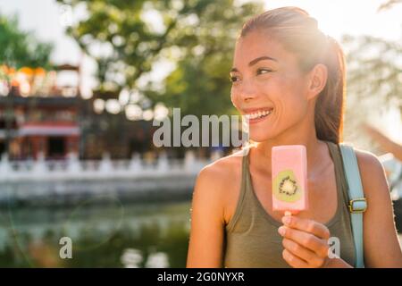 Happy asian girl tourist eating delicious ice-cream gelato in front of ...