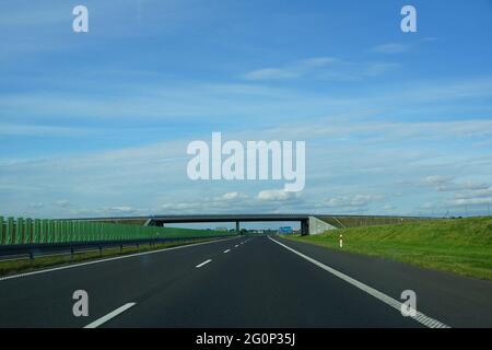 Closeup shot of an empty highway and a bridge under the blue sky Stock ...