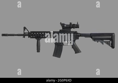 M4 Carbine with optic sight and a foregrip on yellow background Stock ...