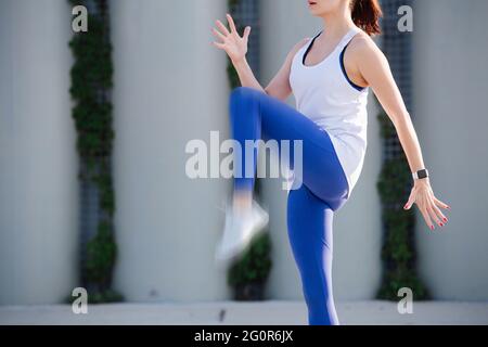 A girl in clothes up to her knees turns her head, showing the beauty of ...
