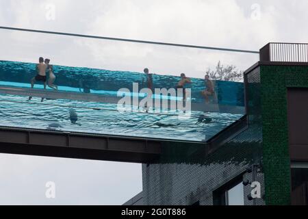 London, UK. Residents of Embassy Gardens in Nine Elms enjoy a swim in ...