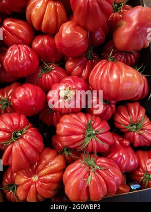 Big ripe french tomatoes, food background close up Stock Photo - Alamy