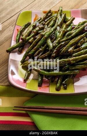 Chinese spicy sichuan garlic string beans with chop sticks Stock Photo ...