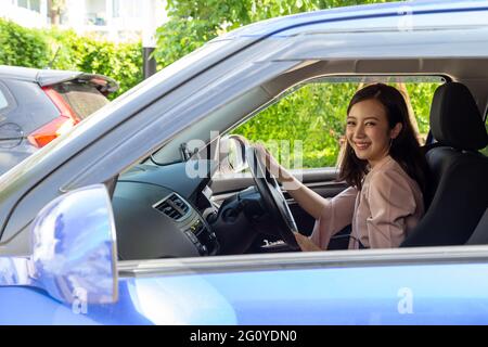 Asian women driving a car and smile happily with glad positive ...