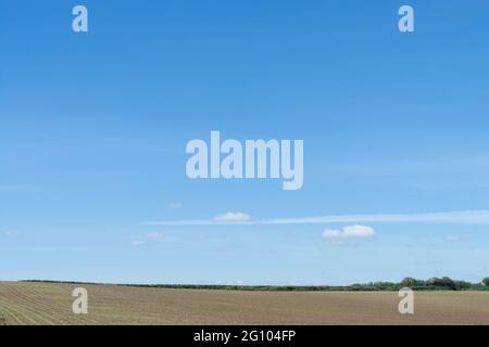 Azure summer blue sky with sparse fluffy clouds on the horizon of ...