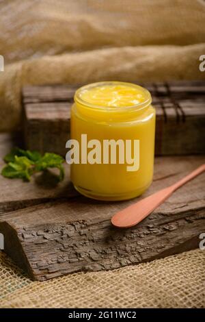 Ghee clarified butter in glass jar top view isolated on white ...