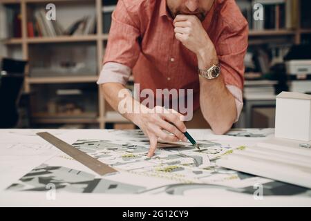 Architect with blueprints and layout design project at office bureau ...