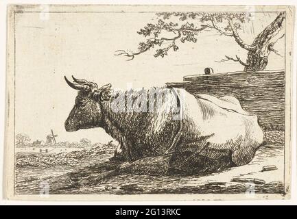 Landscape with lying cow with deck on the back Stock Photo - Alamy