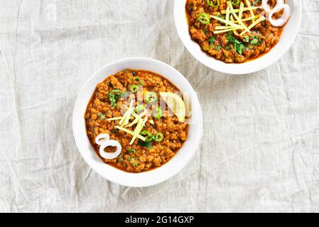 Keema curry in bowls over dark stone background with free space. Indian ...