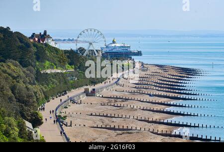 Eastbourne, UK. 5th June 2021. A runner and his dog pass through a ...
