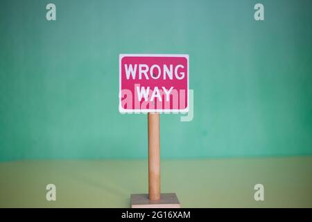 Closeup shot of a red "Wrong Way" sign on a blurred background Stock ...