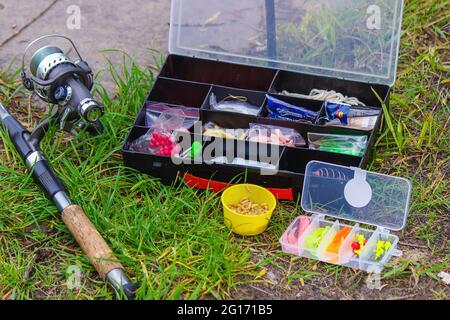 Fishing rod, spinning reel and a cup of hot coffee on the bank of the ...