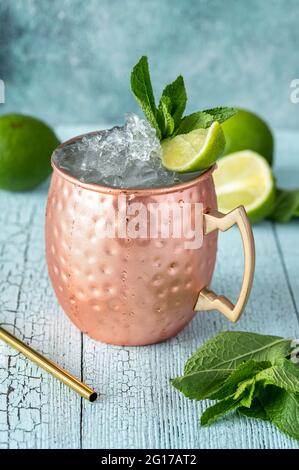 Copper mug of Moscow mule cocktail garnished with mint and lime Stock ...