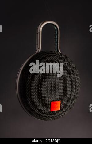 round portable black bluetooth audio speaker with elevated view and ...