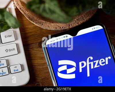 In this photo illustration, a Pfizer logo seen displayed on a ...