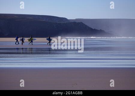 Three surfers going for surfing with their own photograph Stock Photo ...