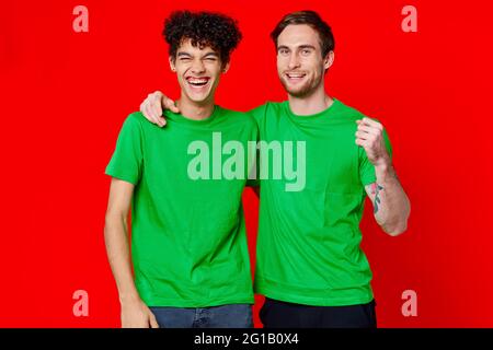 funny friends green t-shirts hugs emotions joy red background Stock ...