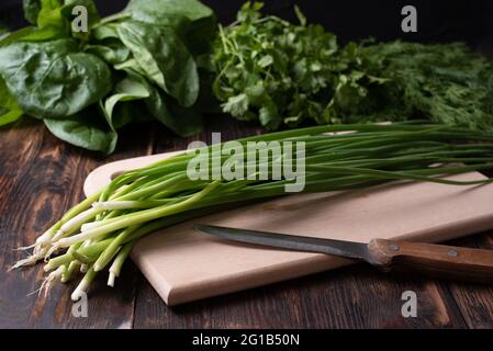 bunch of green onions on the dark background Stock Photo - Alamy