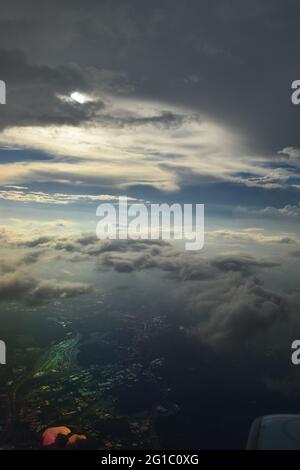 Flying over stormy clouds with blue sky aerial shot Stock Photo - Alamy