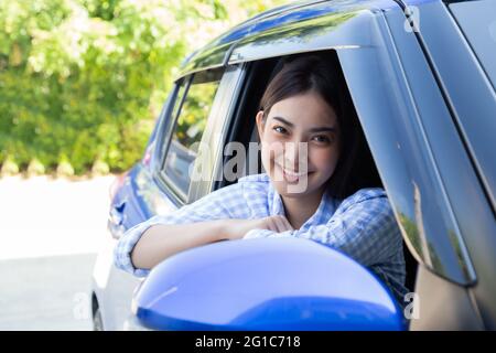 Asian women driving a car and smile happily with glad positive ...