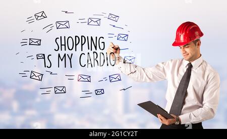 Young businessman with helmet drawing sale sign Stock Photo - Alamy
