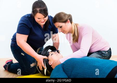 First aiders practicing to remove the helmet of injured biker Stock ...