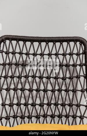 Black wicker chair with yellow pillows. Details Stock Photo - Alamy