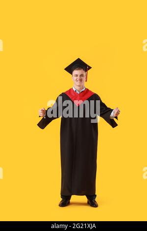 Happy graduating student on color background Stock Photo - Alamy