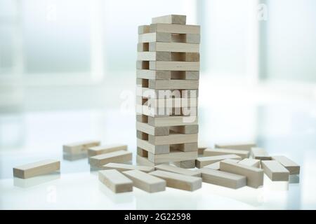 Wood Jenga on glass table Stock Photo - Alamy