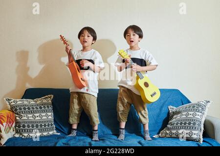 Young Japanese twins Stock Photo - Alamy