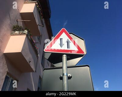 Triangular two way traffic ahead road sign Stock Photo - Alamy