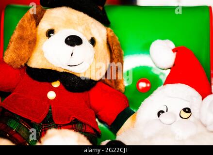 Chrismas dog doll and Smurf doll on green sofa with red rim Stock Photo ...