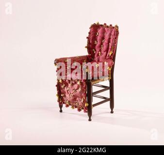 Resting on a chair turned backwards, this female teen smiles with her ...