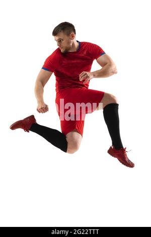 Powerful, flying above the field. Young football, soccer player in ...