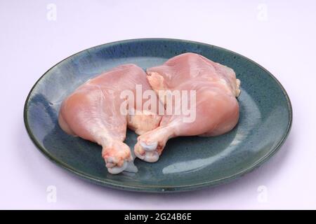 Raw whole chicken leg without skin arranged in a wooden board and ...