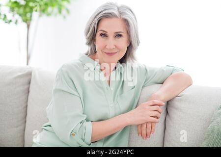 Photo of adorable nice lady sit comfort chair touch accessory satisfied ...