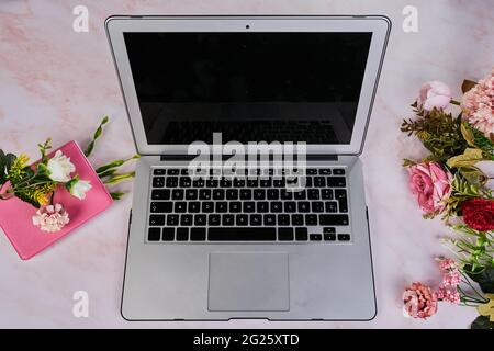Laptop with a pink photo camera and an album and flowers Stock Photo ...