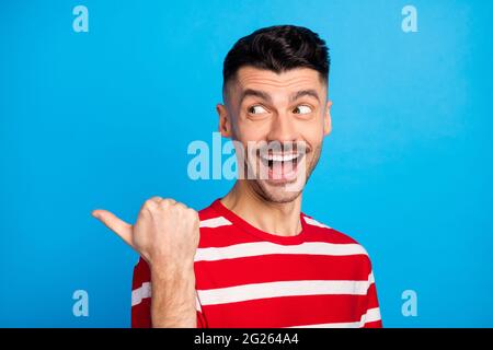 Photo of surprised optimistic brunet hair guy smile hold fists wear ...