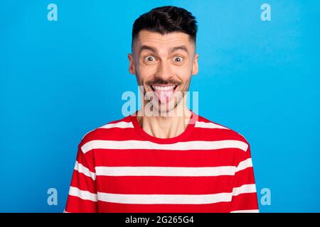 Photo of funky charming young guy dressed pink t-shirt showing v-sing ...