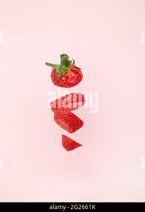 The composition of flying strawberries on pink background. Strawberry ...