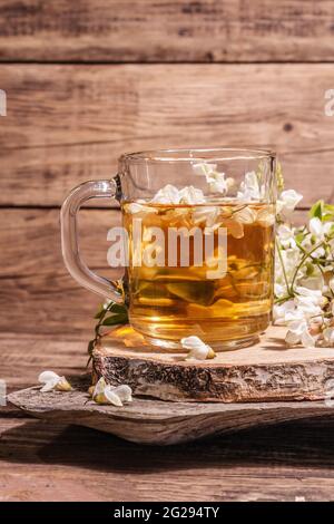 Tea from acacia flowers. Summer healthy vitamin drink, hard light, dark ...