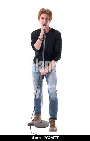 Young redhead man musician singing song playing electrical guitar at ...