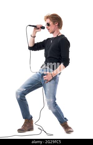 Side view of emotional passionate rock music singer screaming loud on ...