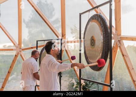Hitting a gong Stock Photo - Alamy