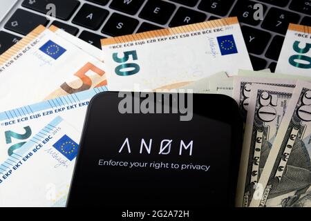 ANOM app logo seen on the smartphone and laptop on blurred background ...