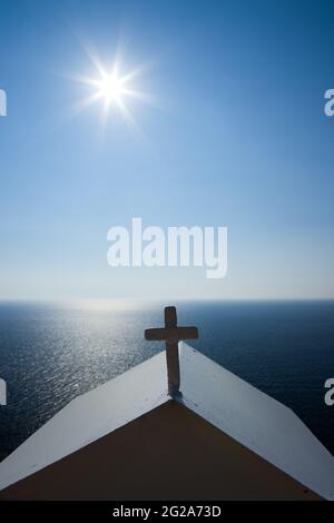 a cross in backlight against the sky blue Stock Photo - Alamy